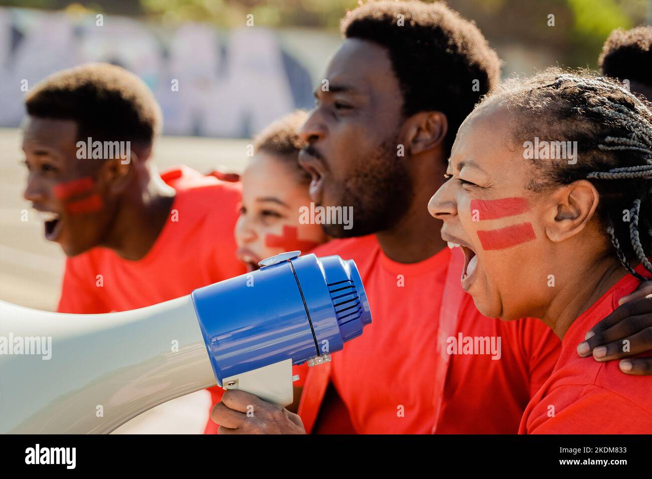 Crazy African red football fans celebrating in the crowd while watching ...