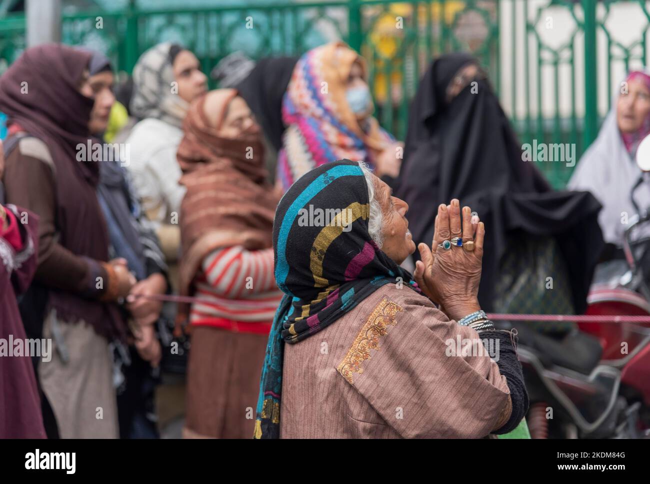 Kashmiri Muslims raise their hands while beseeching for blessings as ...