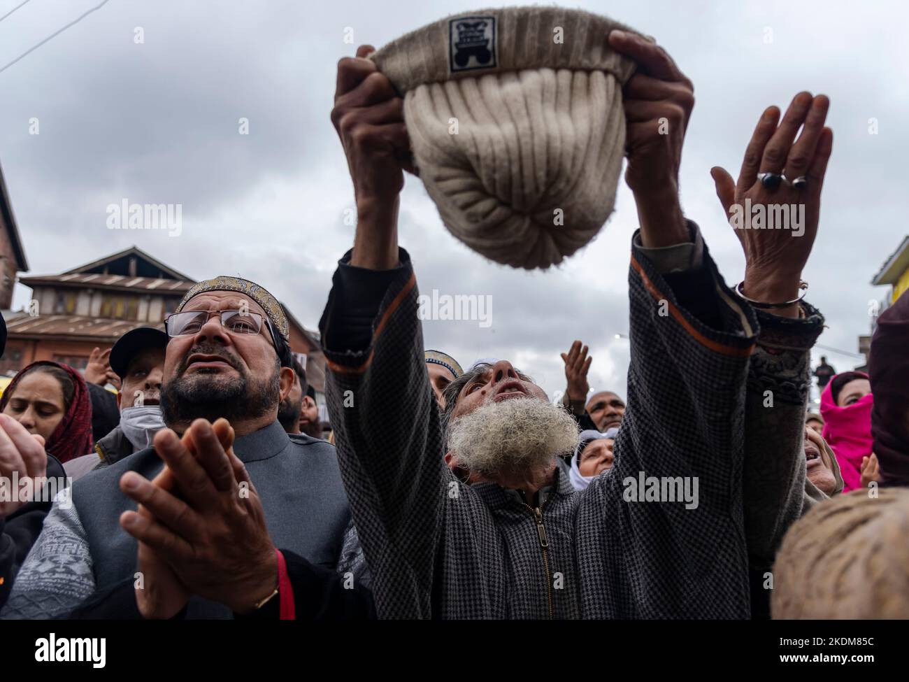 Kashmiri Muslims raise their hands while beseeching for blessings as ...