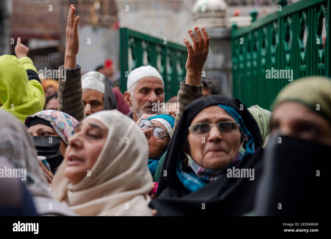 Kashmiri Muslims raise their hands while beseeching for blessings as ...