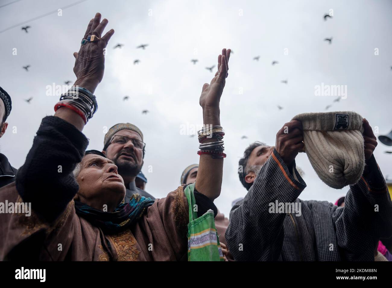 Kashmiri Muslims raise their hands while beseeching for blessings as ...