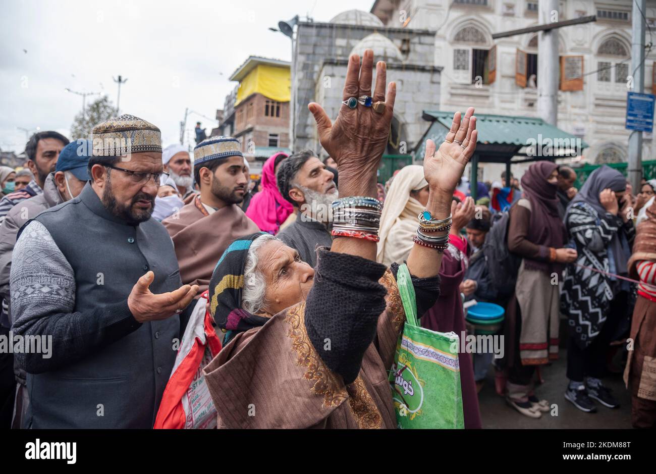 Kashmiri Muslims raise their hands while beseeching for blessings as ...