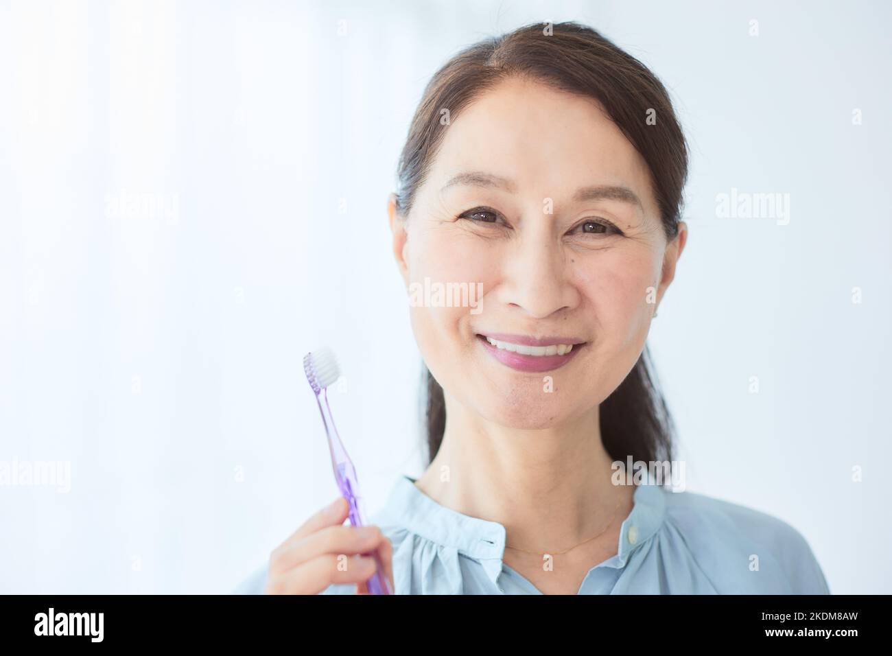 Japanese senior woman brushing teeth Stock Photo - Alamy