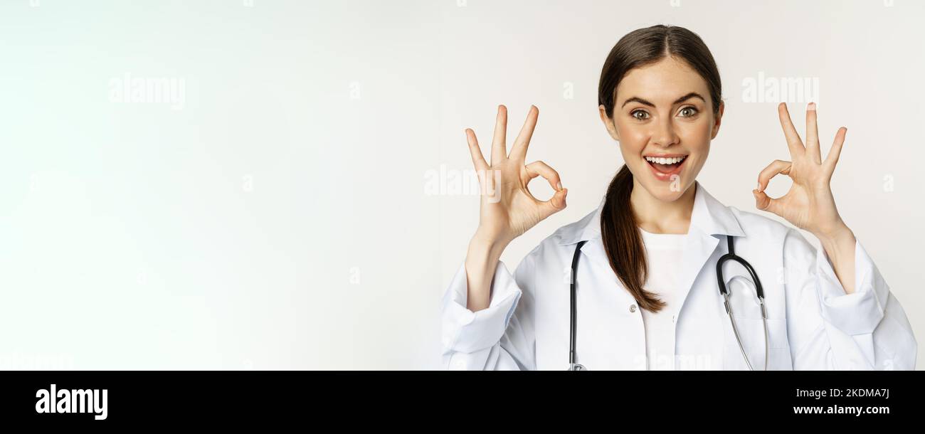 Happy beautiful woman doctor, showing okay, ok excellent sign, smiling ...