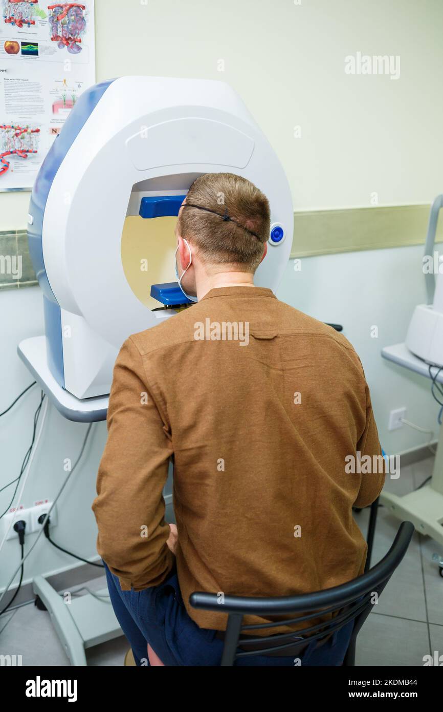 Professional medical equipment scanning the patient's eyes. The device ...