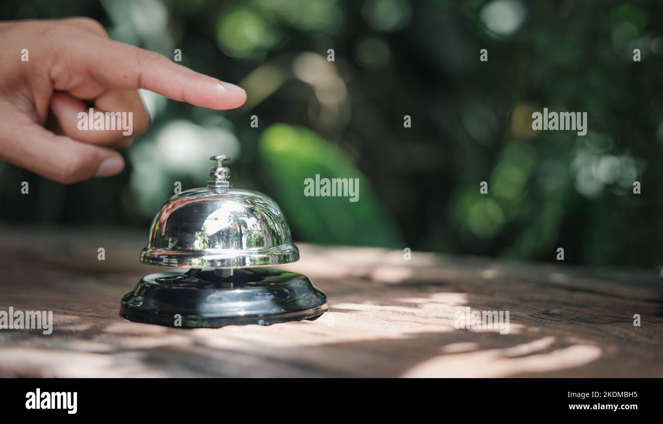 Customer hand ringing service bell at coffee cafe shop for calling the ...