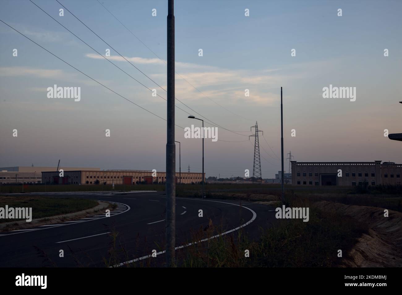 Abandoned warehouses and pylons next to a roundabout in an industrial ...