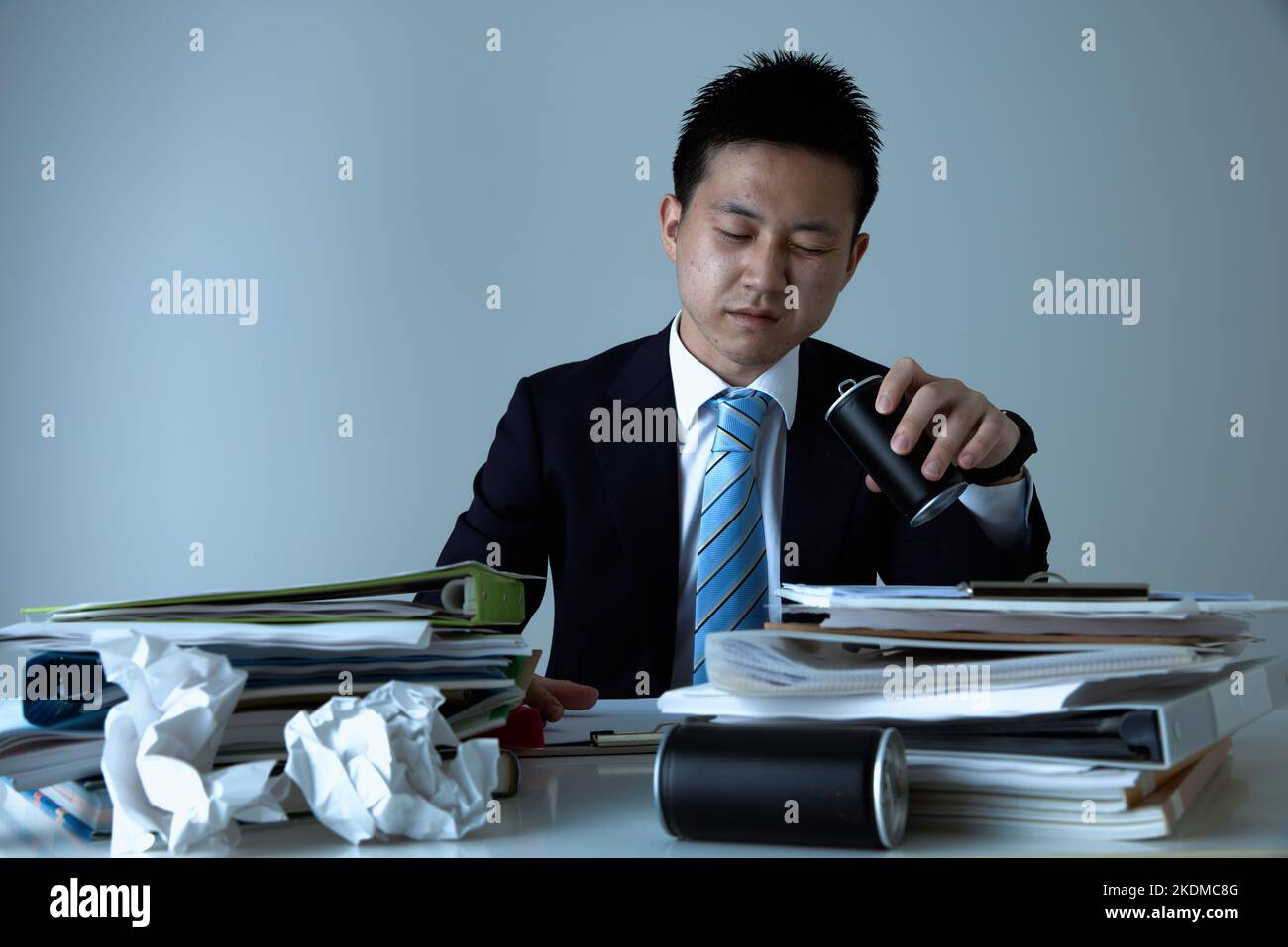 Tired Japanese businessman Stock Photo - Alamy