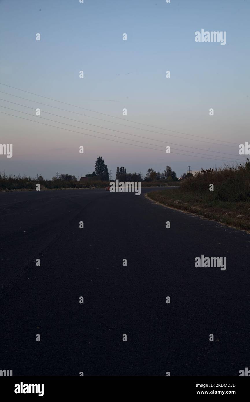 Empty road in an abandoned industrial complex at dusk Stock Photo - Alamy