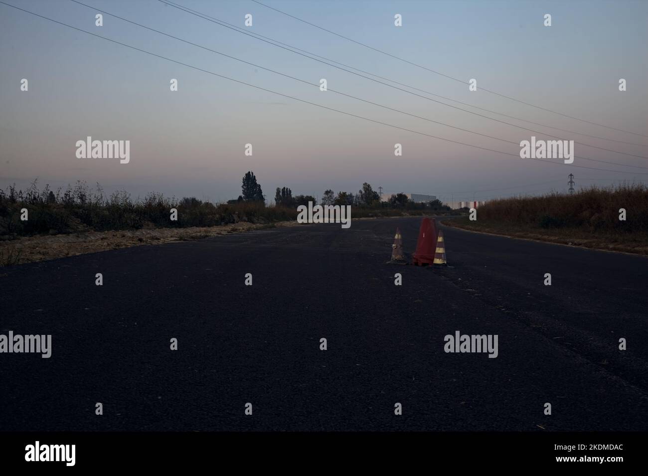 Empty road in an abandoned industrial complex at dusk Stock Photo - Alamy