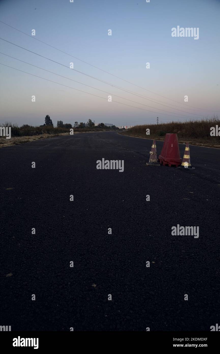 Empty road in an abandoned industrial complex at dusk Stock Photo - Alamy