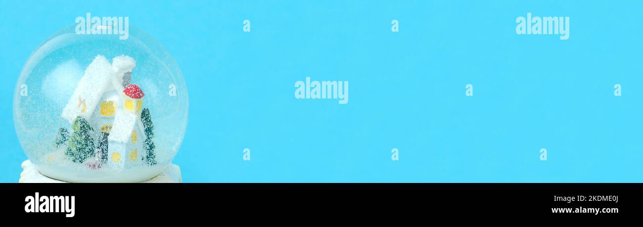 Blue christmas background baner with snow globe with house and fir ...