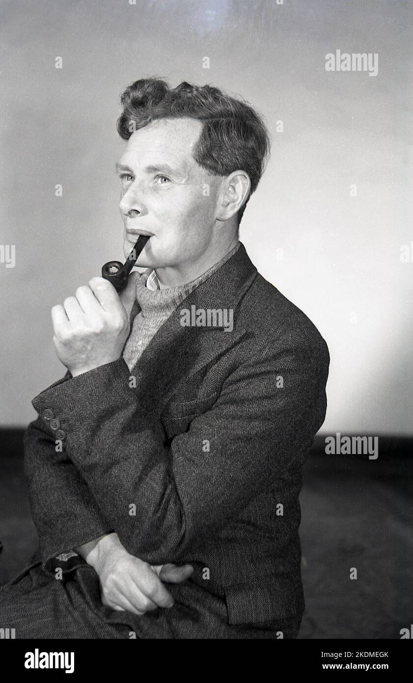 1960s, historical, a man wearing a herring bone tweed suit and rolled ...