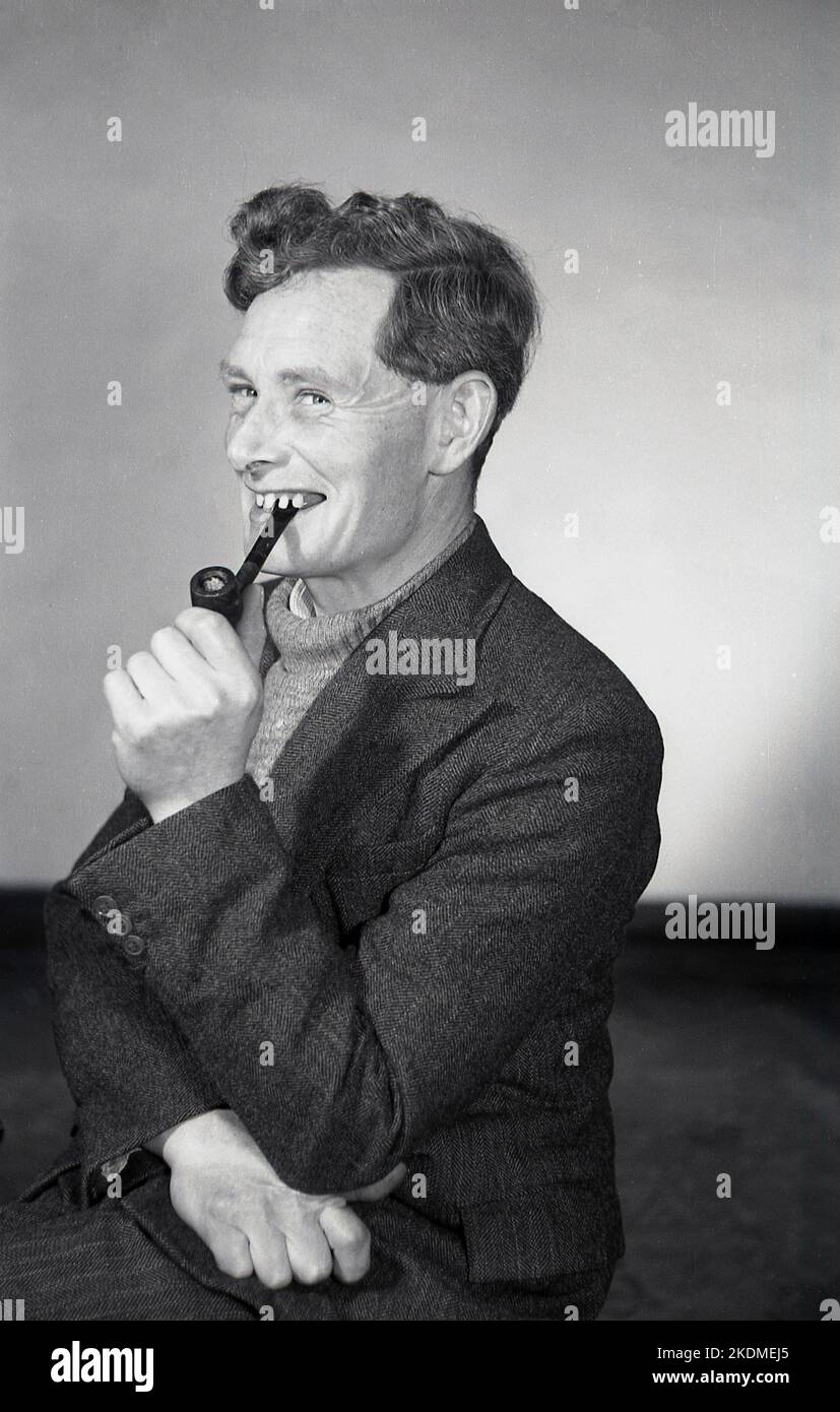 1960s, historical, sitting for his photo, smiling, a man wearing a ...