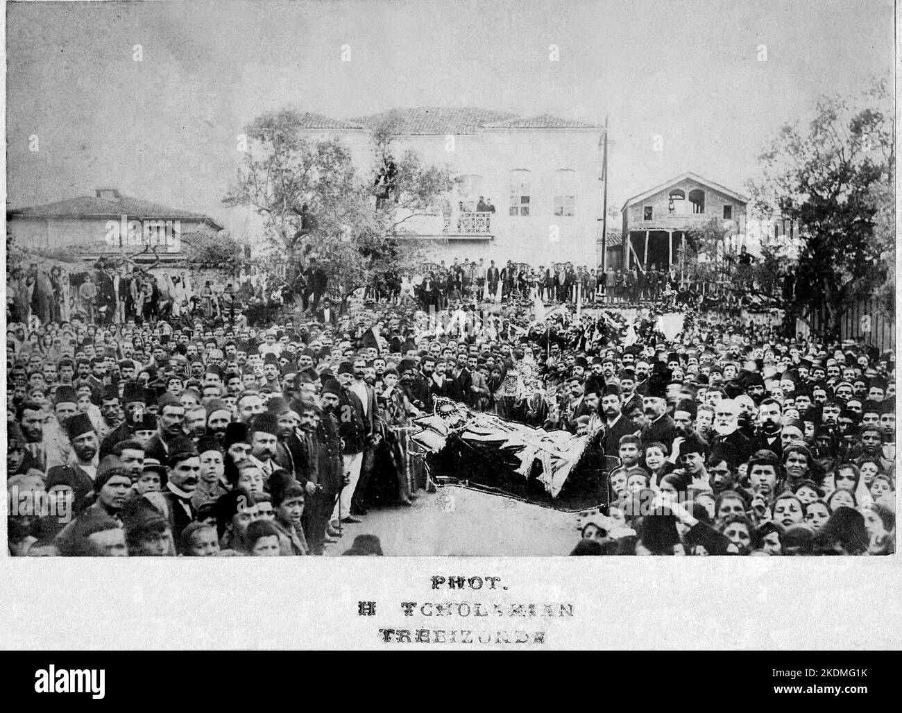 Men and woman gathered for the funeral of an Armenian cleric. Hatchik ...