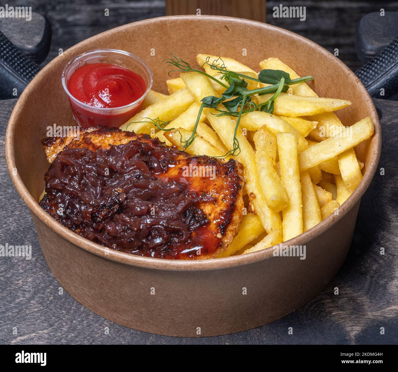 Fried meat, fries and catchup in cardboard bowl. Take away food Stock ...