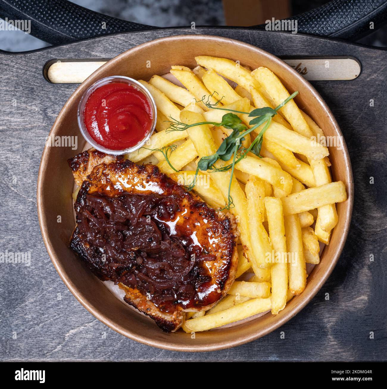 Fried meat, fries and catchup in cardboard bowl. Take away food Stock ...