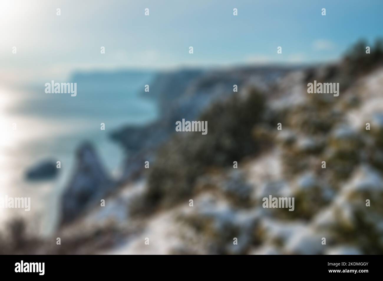 Abstract defocused blured background Snow covered rocky cliffs over sea ...