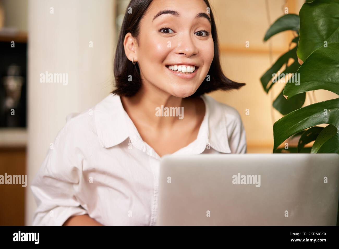 Beautiful young woman with happy smile, sitting in cafe with laptop ...