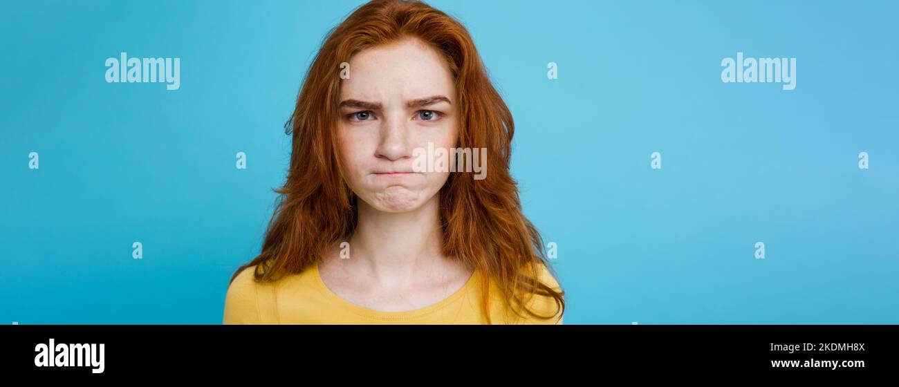Headshot Portrait of tender redhead teenage girl with serious ...
