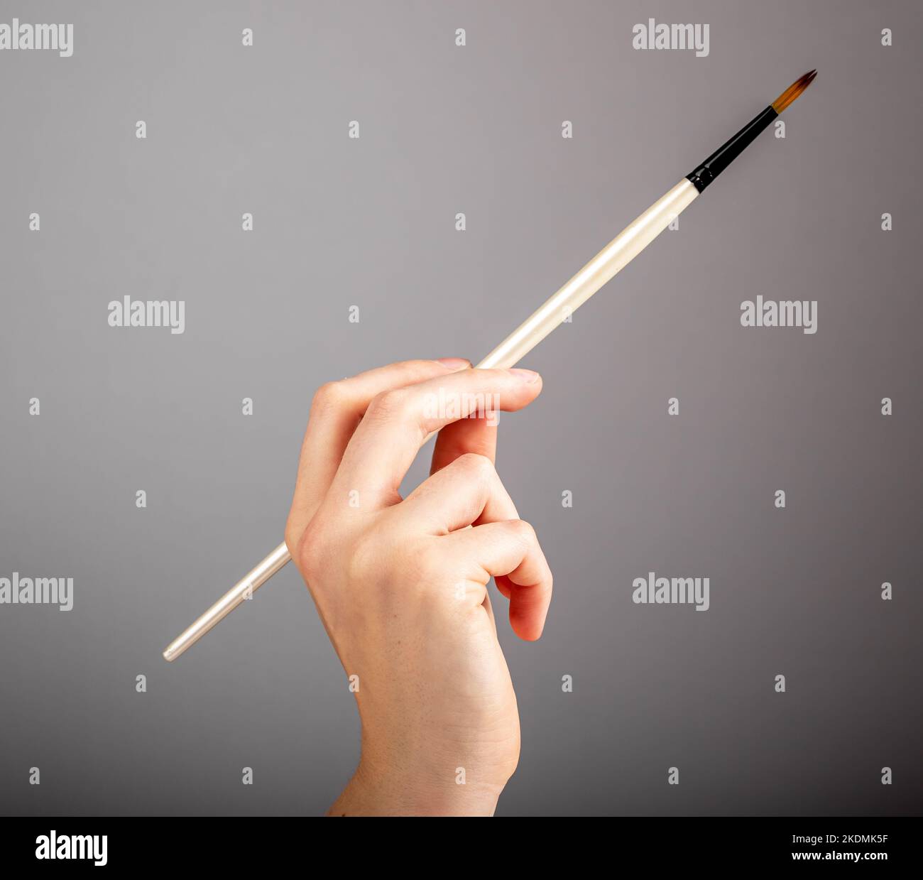 Paint brush, paintbrush in hand of painter, making stroke in air on ...