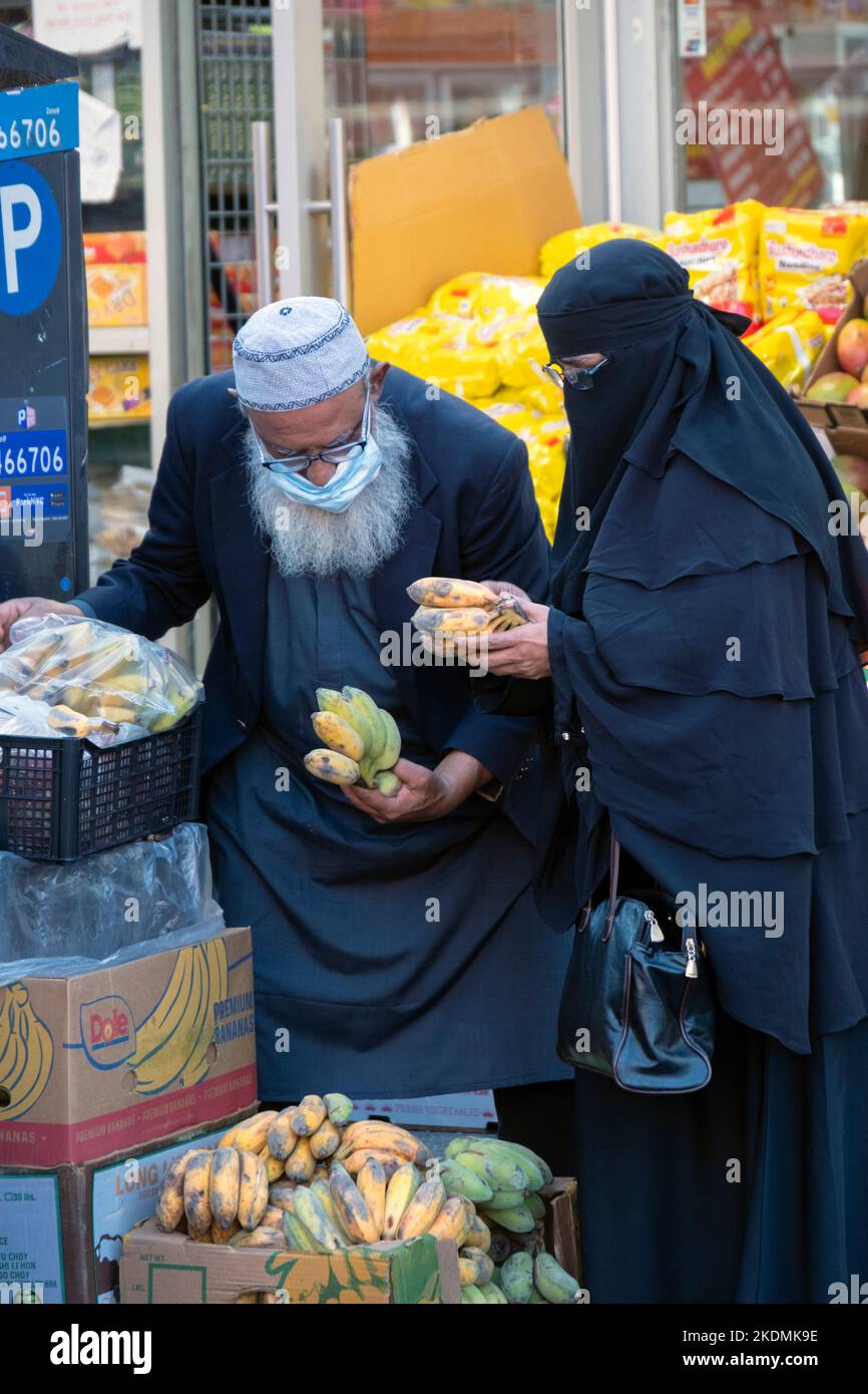 A muslim couple shop for bananas at an outdoor stand at the Apna ...