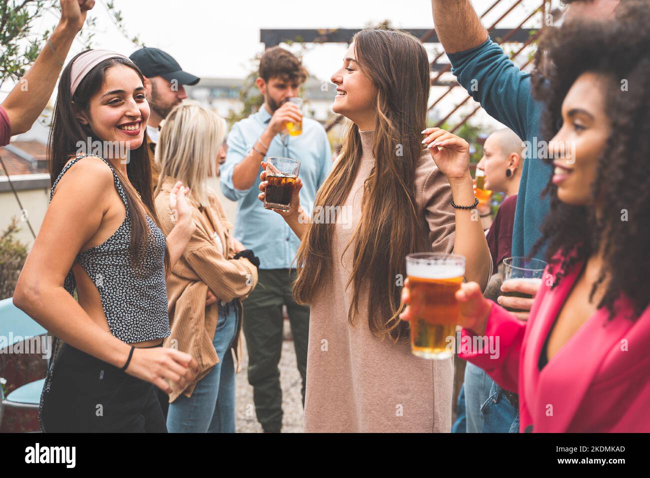 Happy community of multiethnic friends having fun dancing together at ...