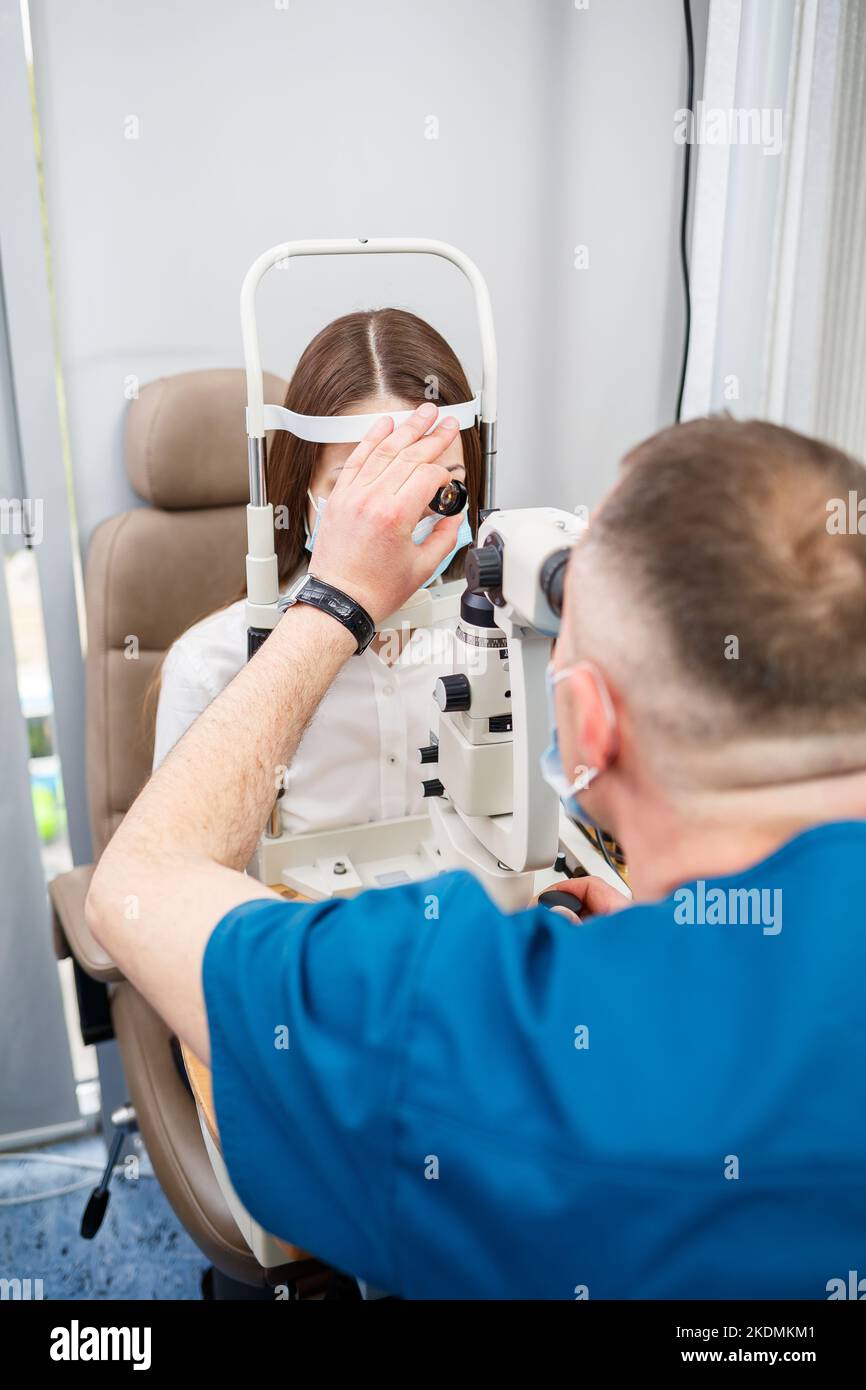 An optometrist at his clinic studies vision. Ophthalmology, medical ...