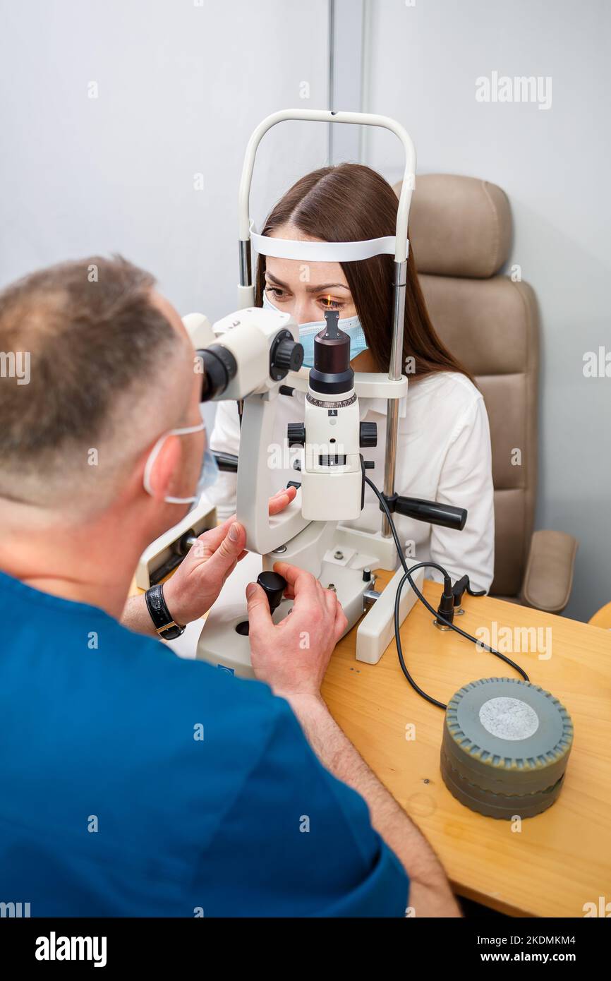 An optometrist at his clinic studies vision. Ophthalmology, medical ...