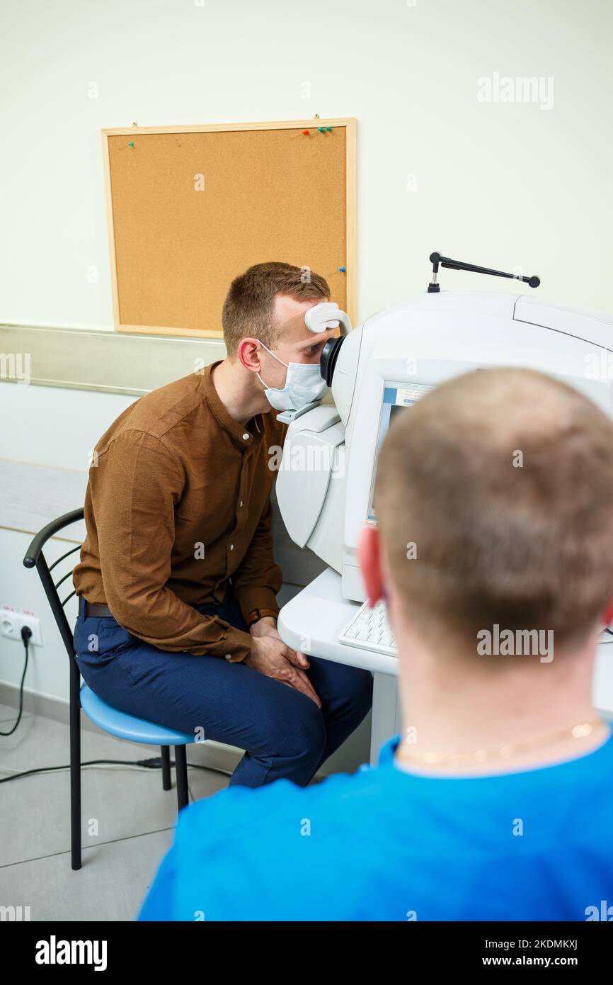 Professional medical equipment scanning the patient's eyes. The device ...
