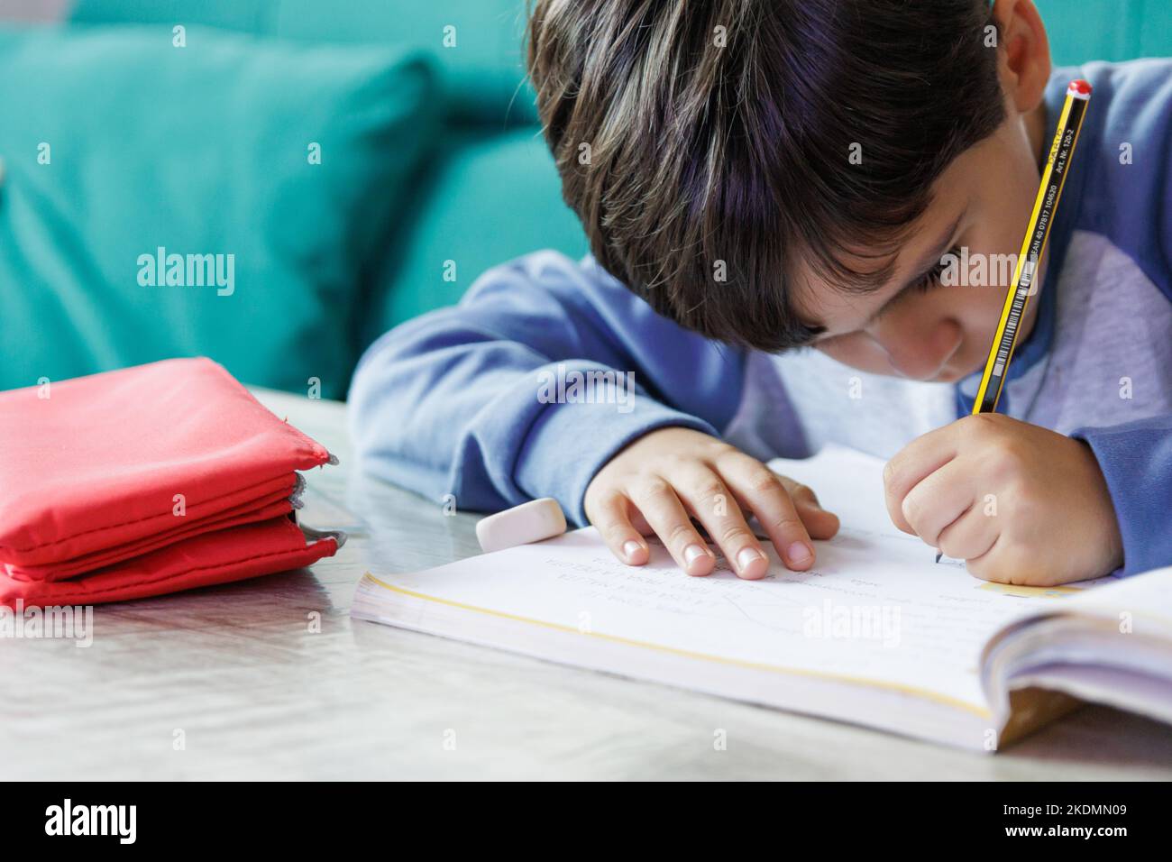 Boy doing homework at home Stock Photo - Alamy