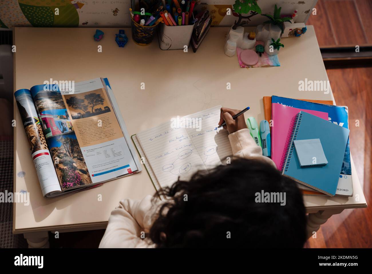 View from above of african teen doing homework at home Stock Photo - Alamy