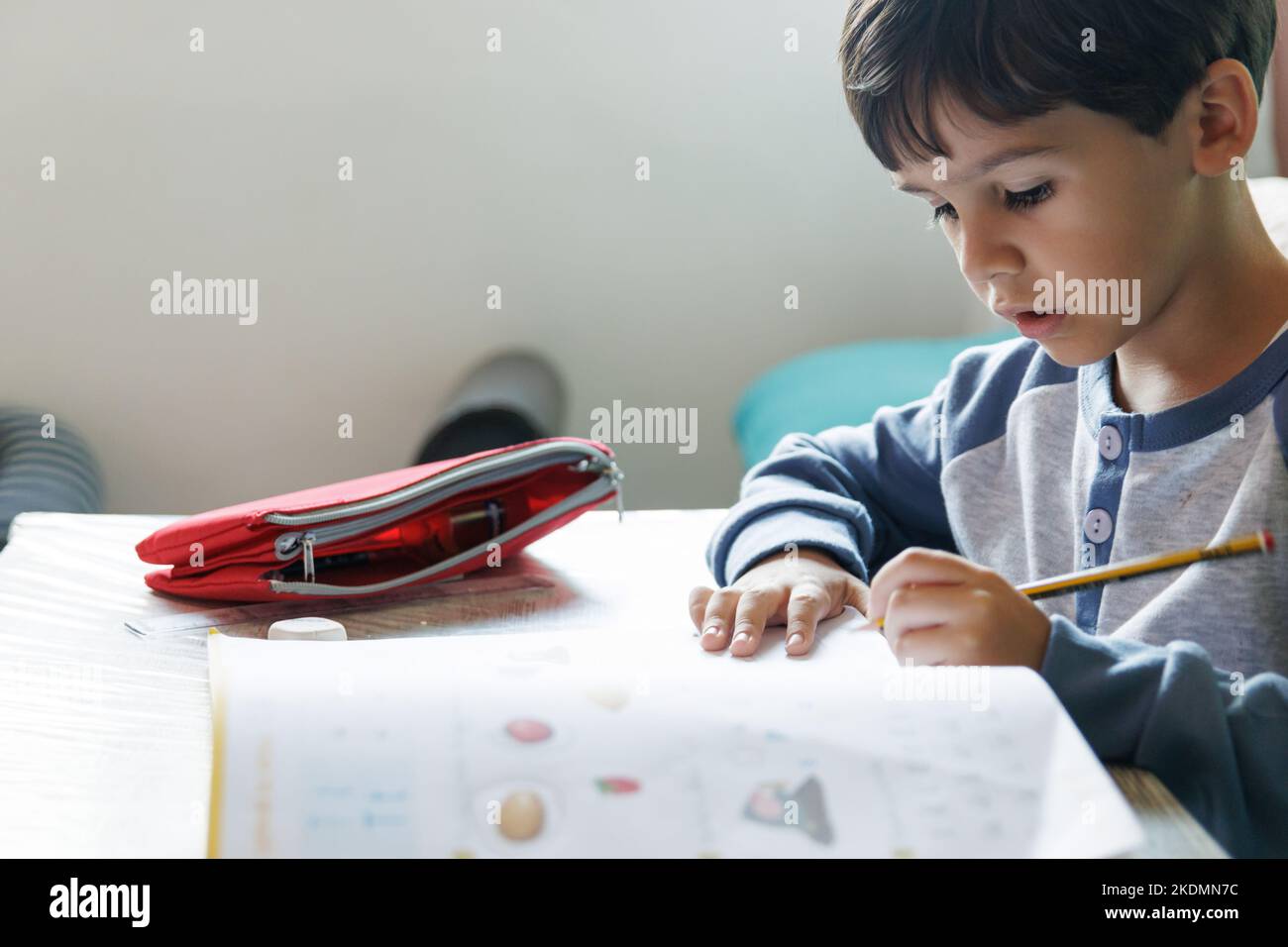 Boy doing homework at home Stock Photo - Alamy