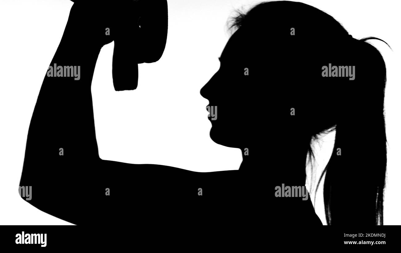 on a white background, a shadow, a black outline of a female figure ...