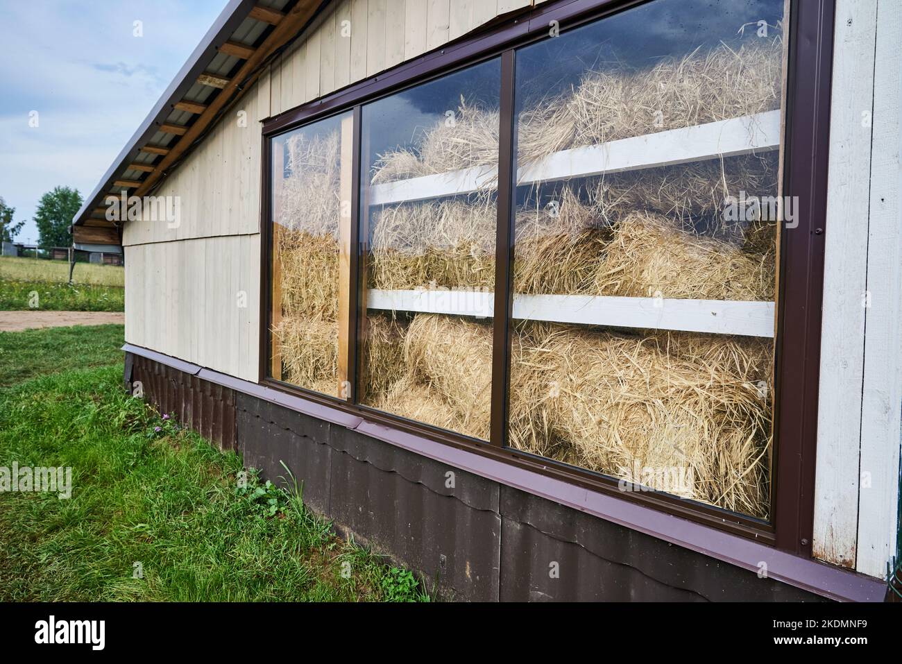A barn with a large window and hay inside Stock Photo - Alamy