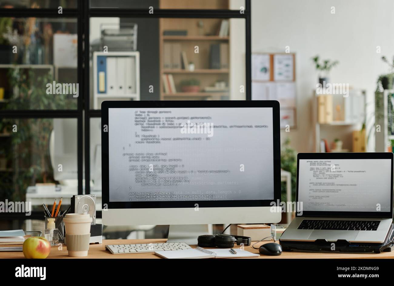 Workplace of IT professional with coded data on screens of computer and ...