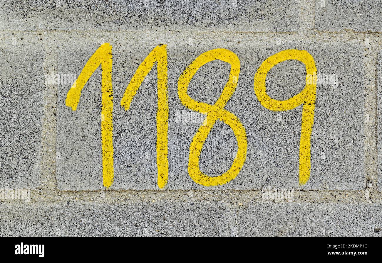 Street sign number 1189 on a concrete wall Stock Photo - Alamy