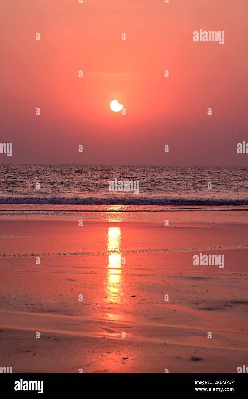 Gushing sea waves illuminated by narrowing beam of eclipsed sun Stock ...