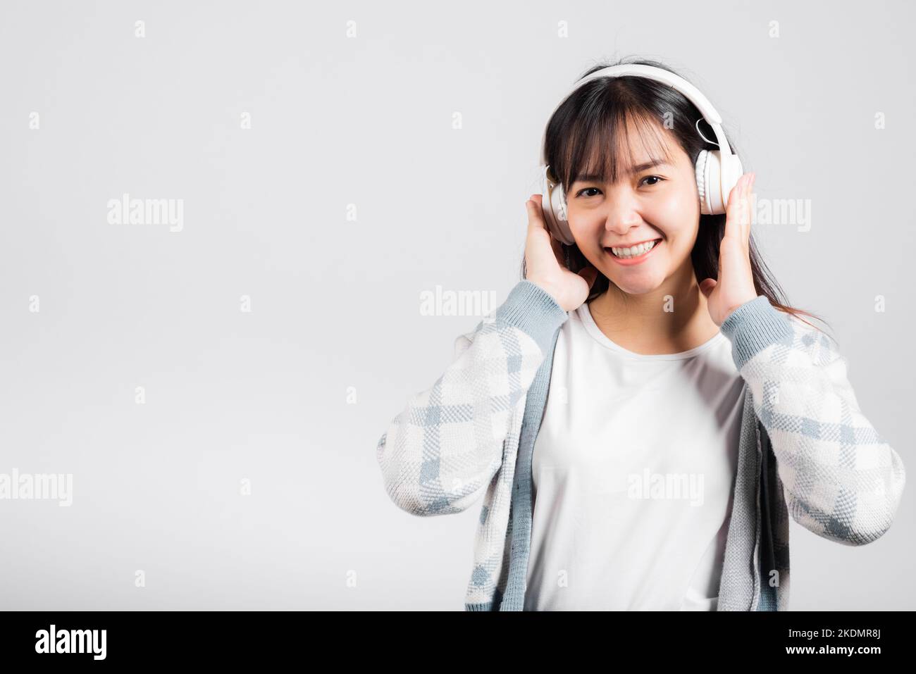 Woman excited smiling listening to music radio in bluetooth headphones ...