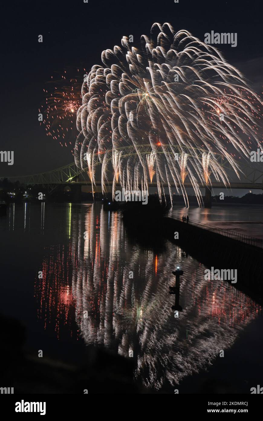 Relections in the Manchester Ship Canal of the exploding fireworks ...