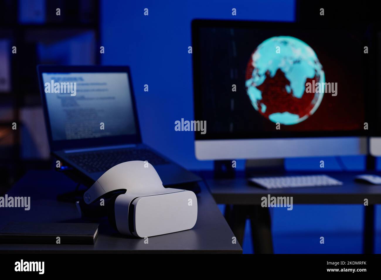 Selective focus on VR headset lying on workplace of programmers with ...