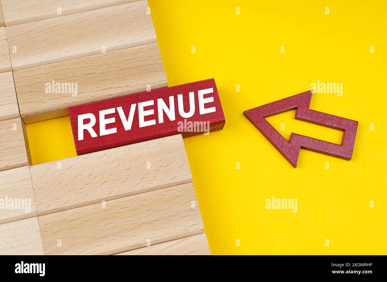 Business concept. On a yellow surface are wooden blocks and an arrow ...