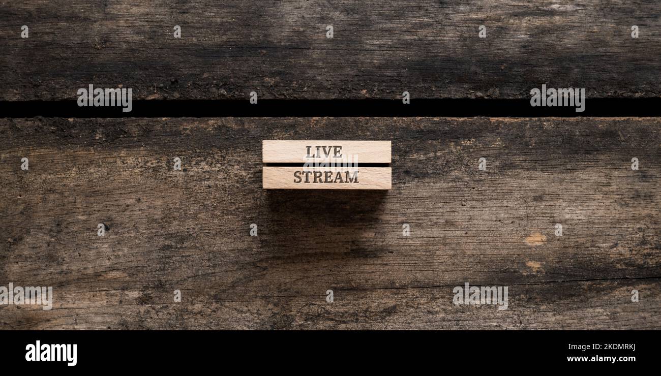 Live stream sign written on two stacked wooden pegs placed over ...