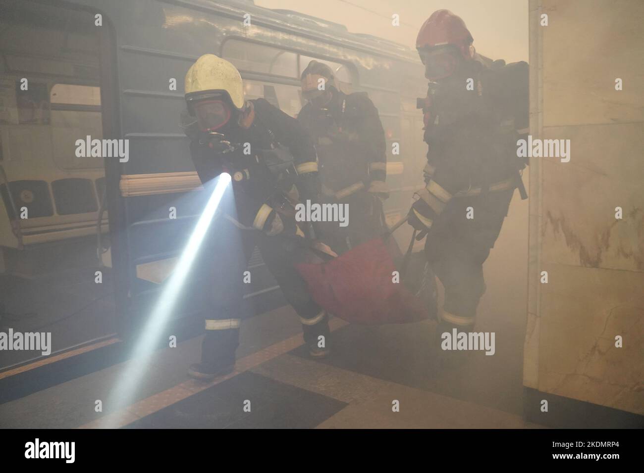 The concept of the rescue service. Rescuers-firefighters evacuate on a ...