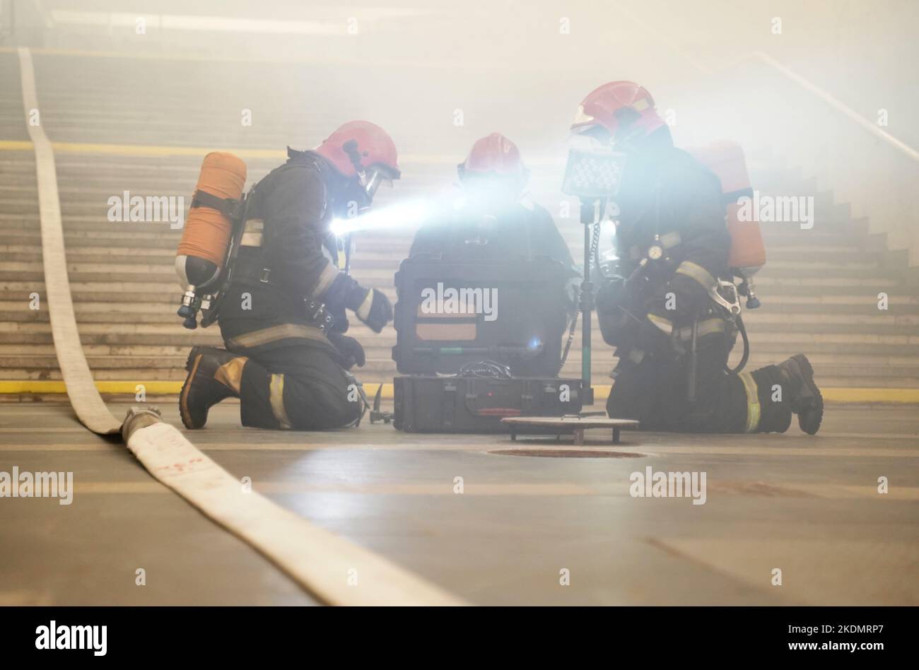 Rescue service concept. Rescuers lay out lighting equipment to work on ...