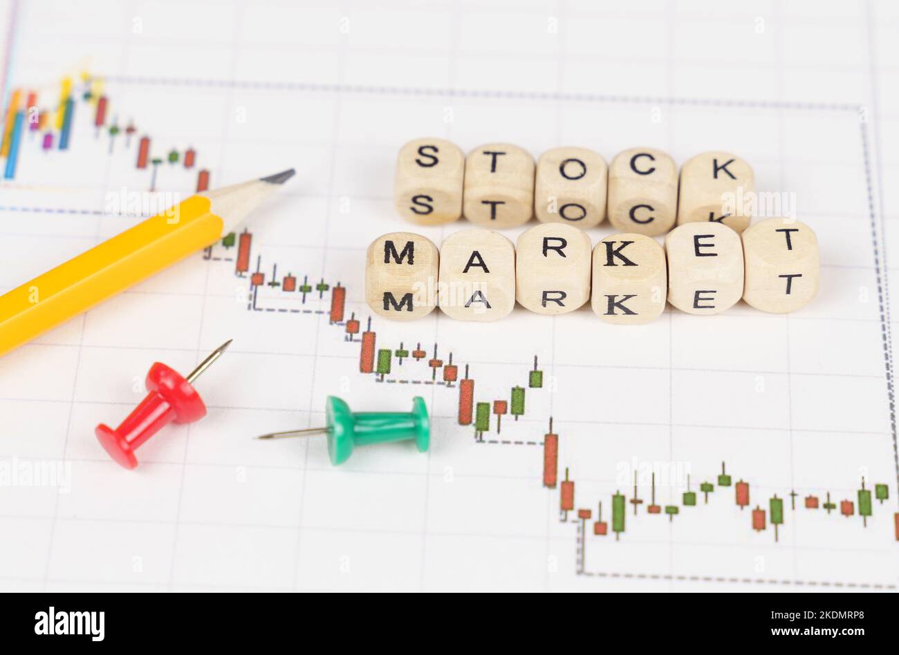 Business concept. On the charts with quotes are a pencil and cubes with ...