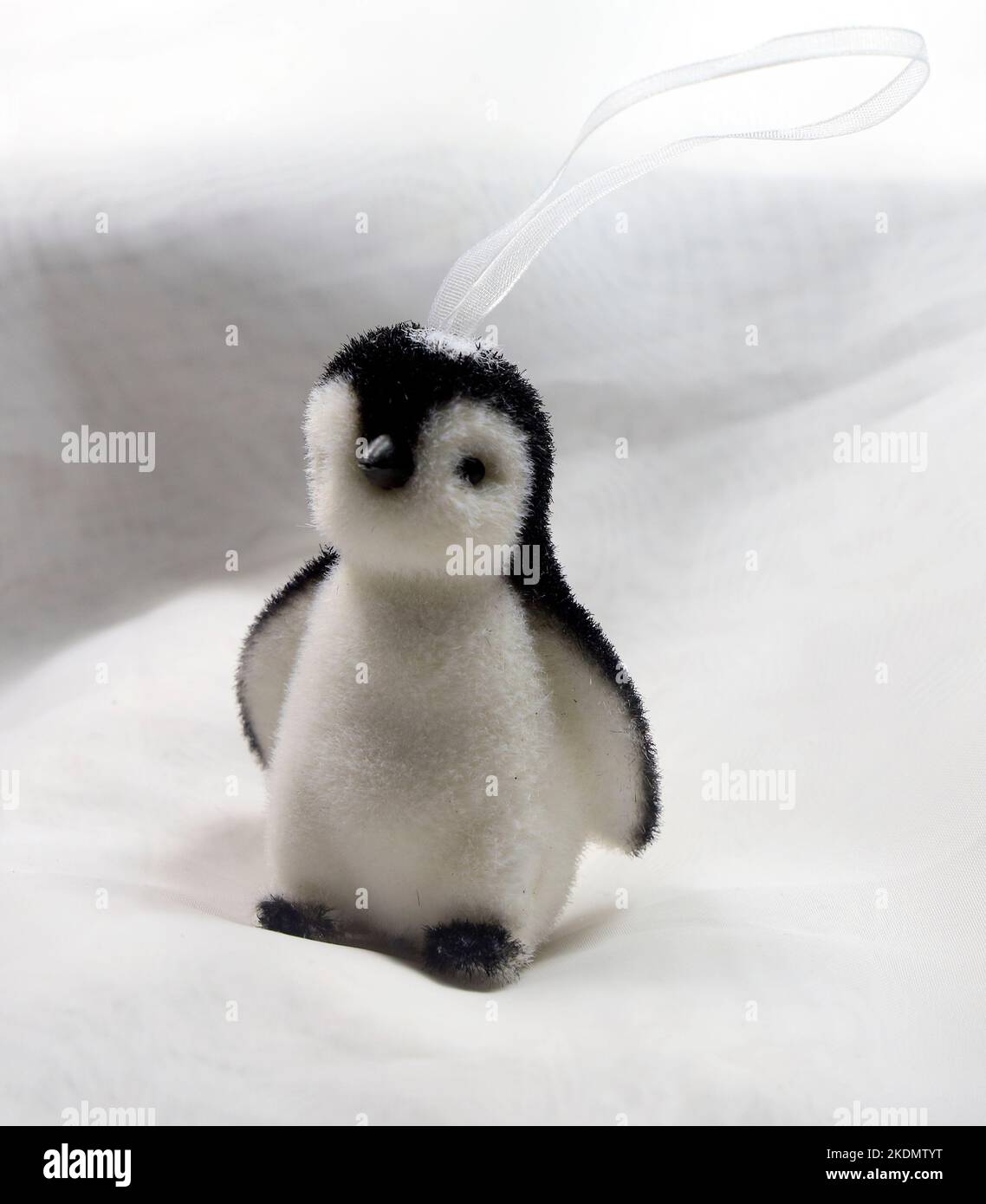 Small penguin Christmas tree decoration on an icy background. Studio ...