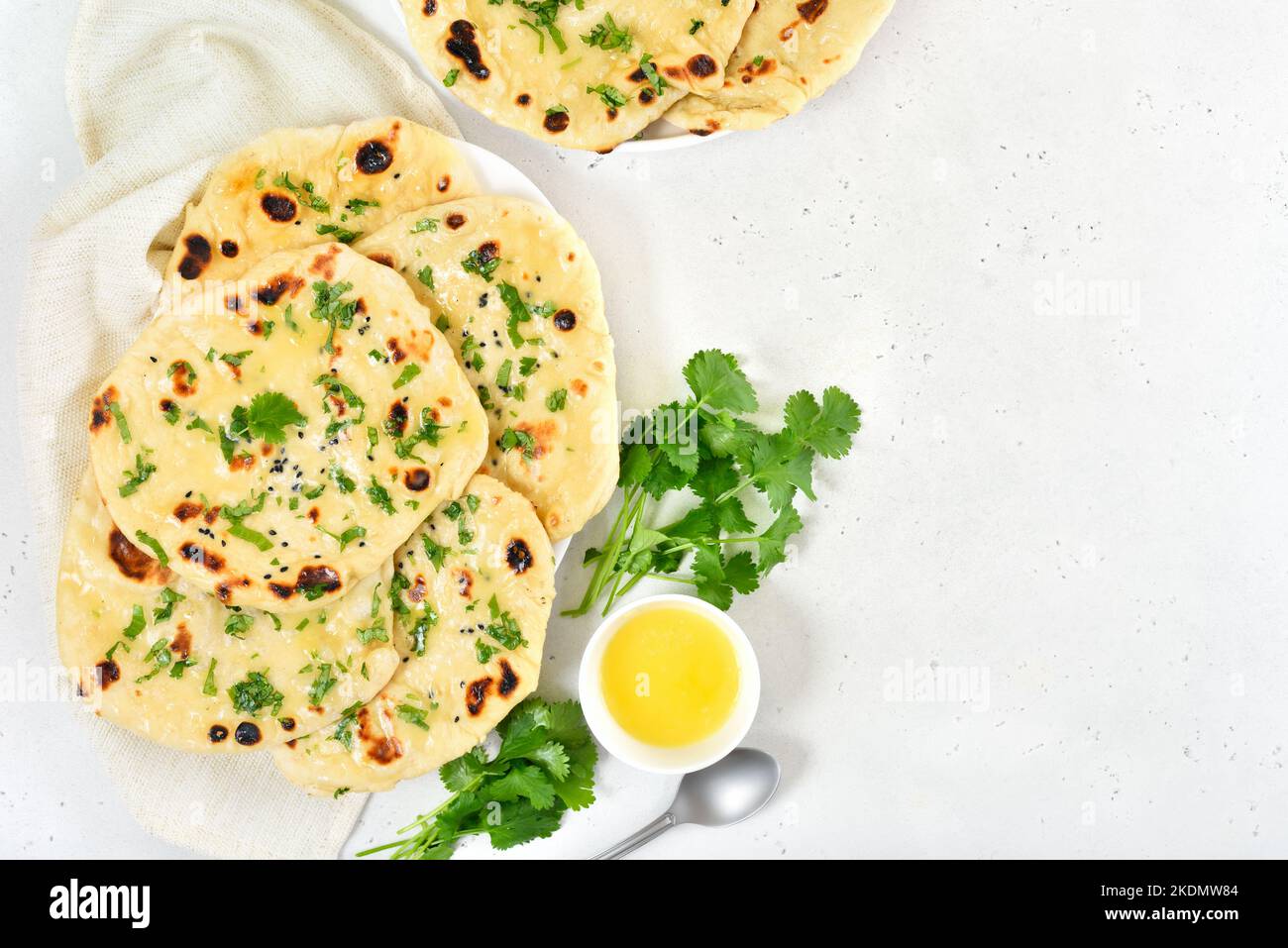 Indian naan bread over light stone background with copy space. Top view ...
