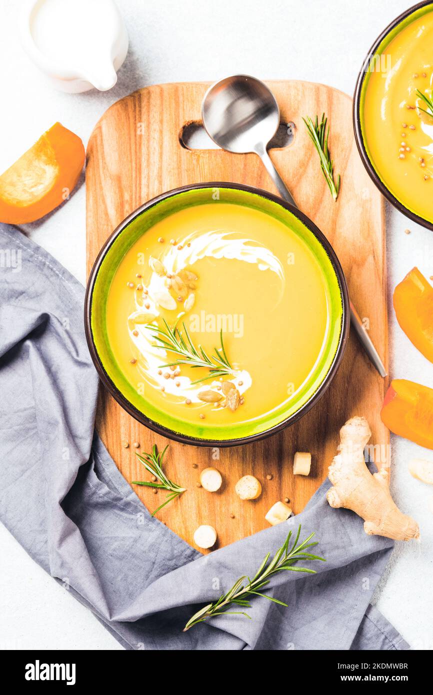 Pumpkin cream soup garnished with heavy cream and rosemary. Thick ...