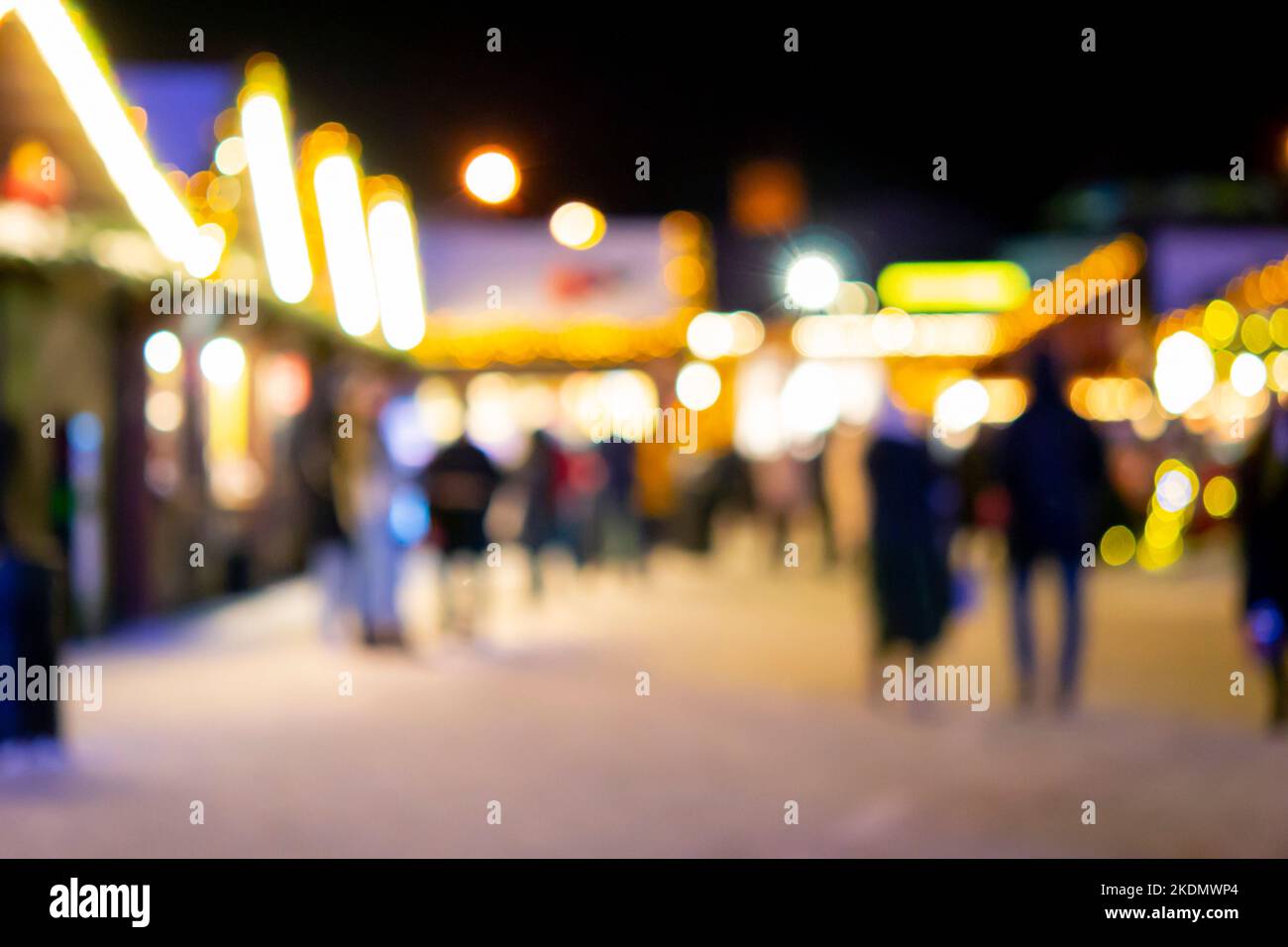 Blurred background. People walk in city square on winter night. Black ...